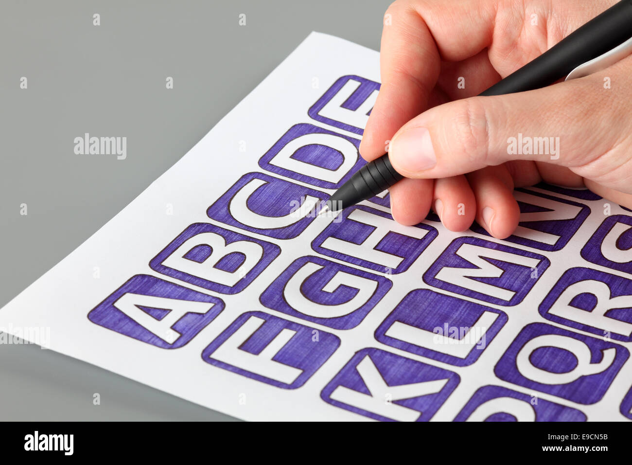Woman's hand with ballpoint pen draw alphabet with letters' blue ...