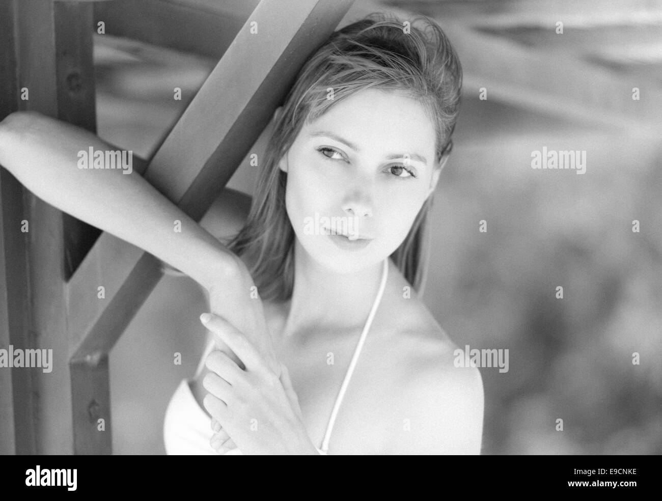 Pretty Girl Standing Under Wooden Pier And Smiling Beautiful Young