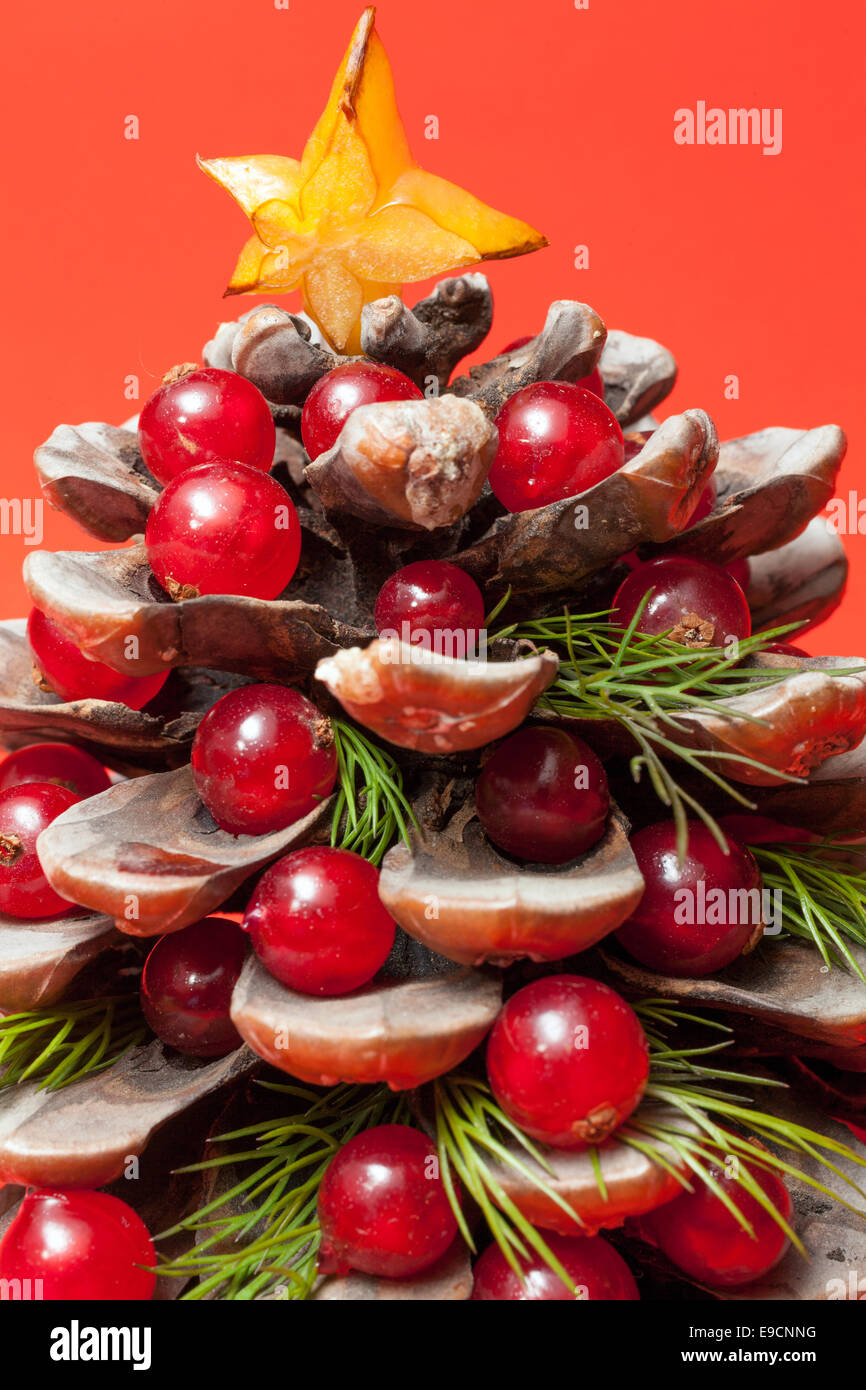 Pine cone decorated with cranberries as tree for Christmas Stock Photo ...