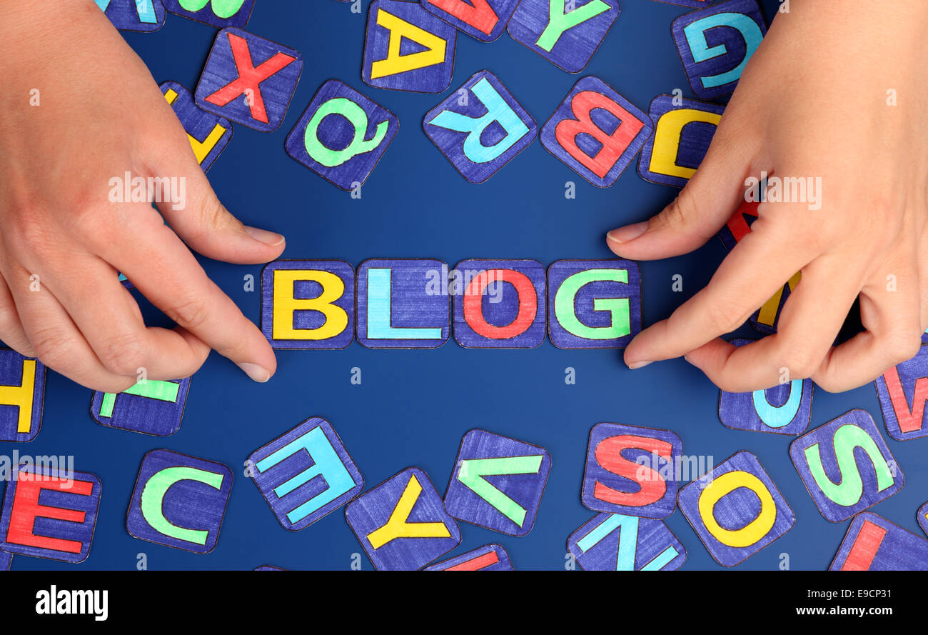 Word "Blog" spell out on blue background with woman's hands and letters ...