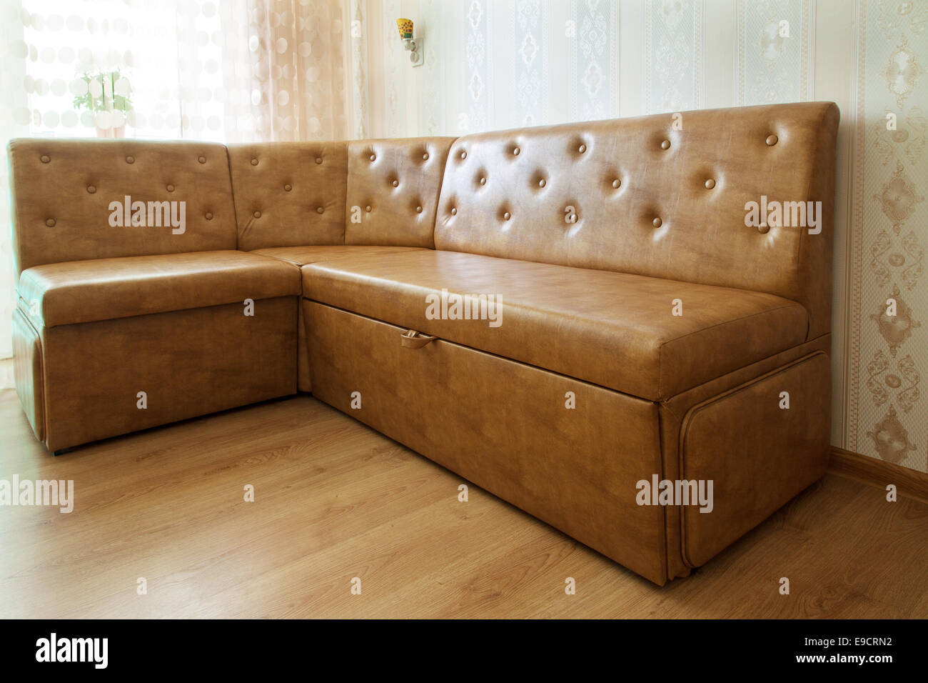 brown leather sofa in a room closeup Stock Photo - Alamy