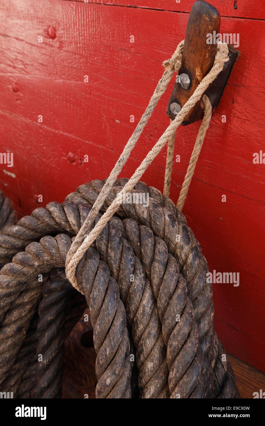 Belaying pin and coiled rope on a tall ship Stock Photo - Alamy
