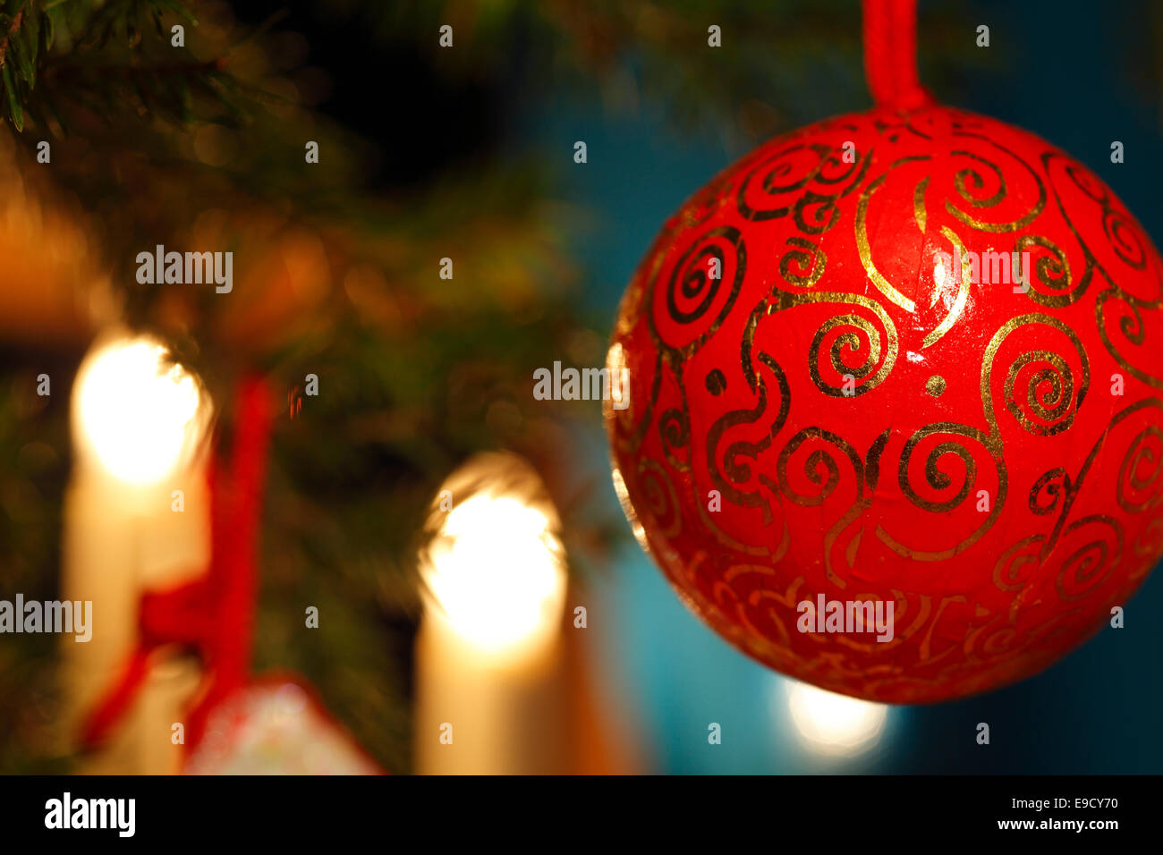 A red bauble is hanging on the Christmas tree Stock Photo - Alamy