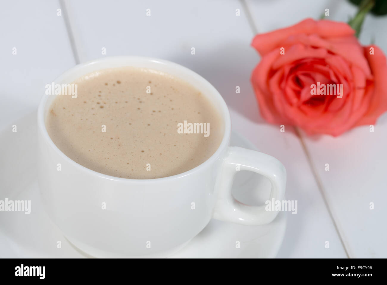 Cups of coffee and pink roses on white background Stock Photo - Alamy