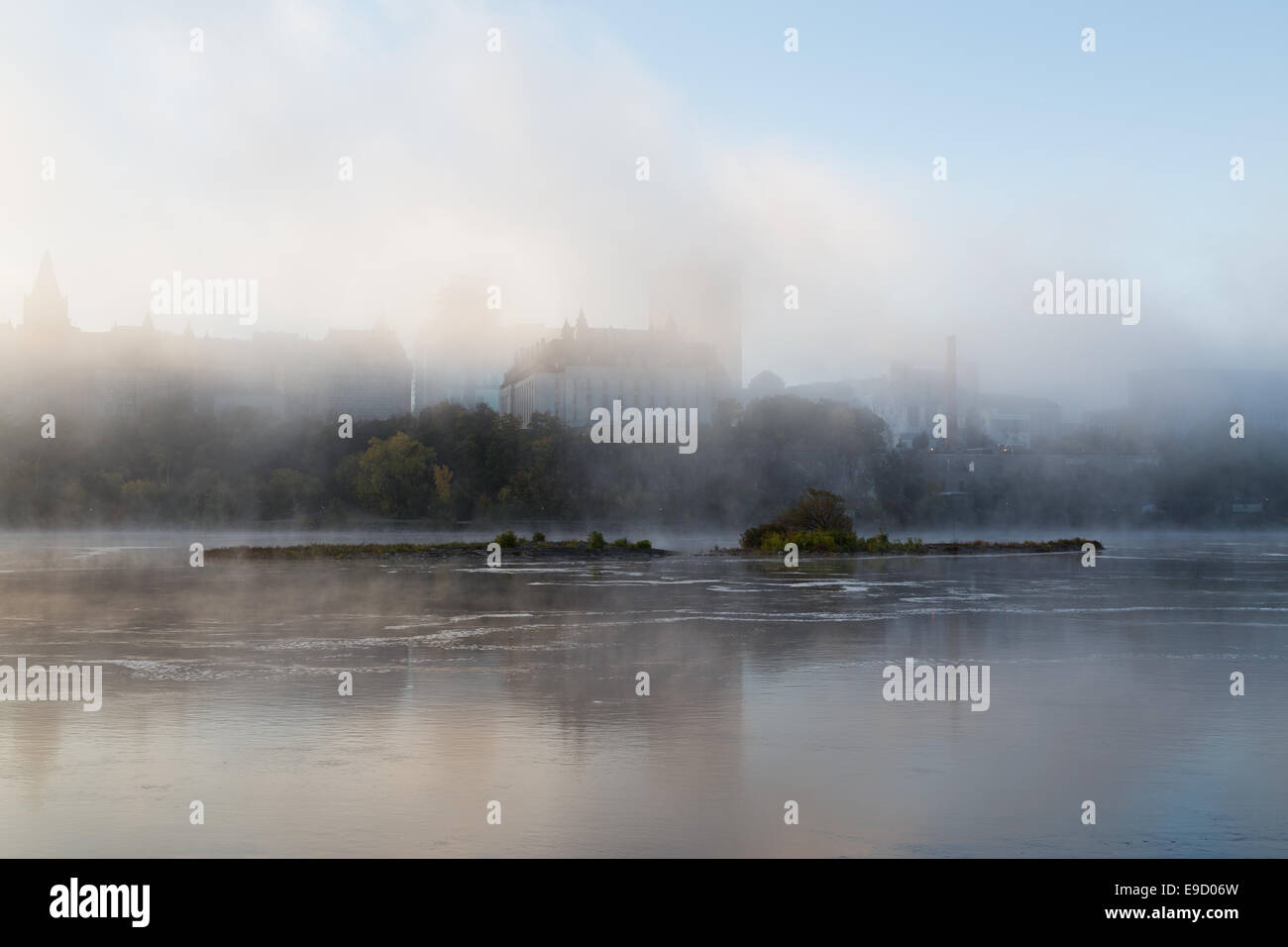 Mist rising from the Ottawa River in the morning with buildings in the ...