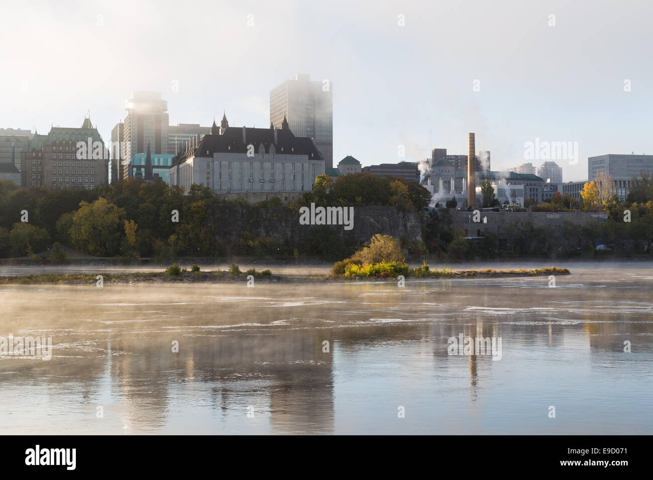 Mist rising from the Ottawa River in the morning with buildings in the ...