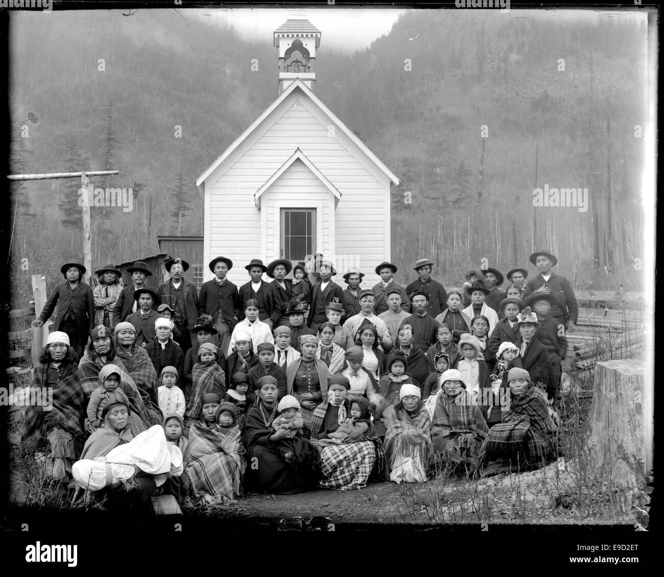 This photograph shows a group of people gathered outside a church in ...