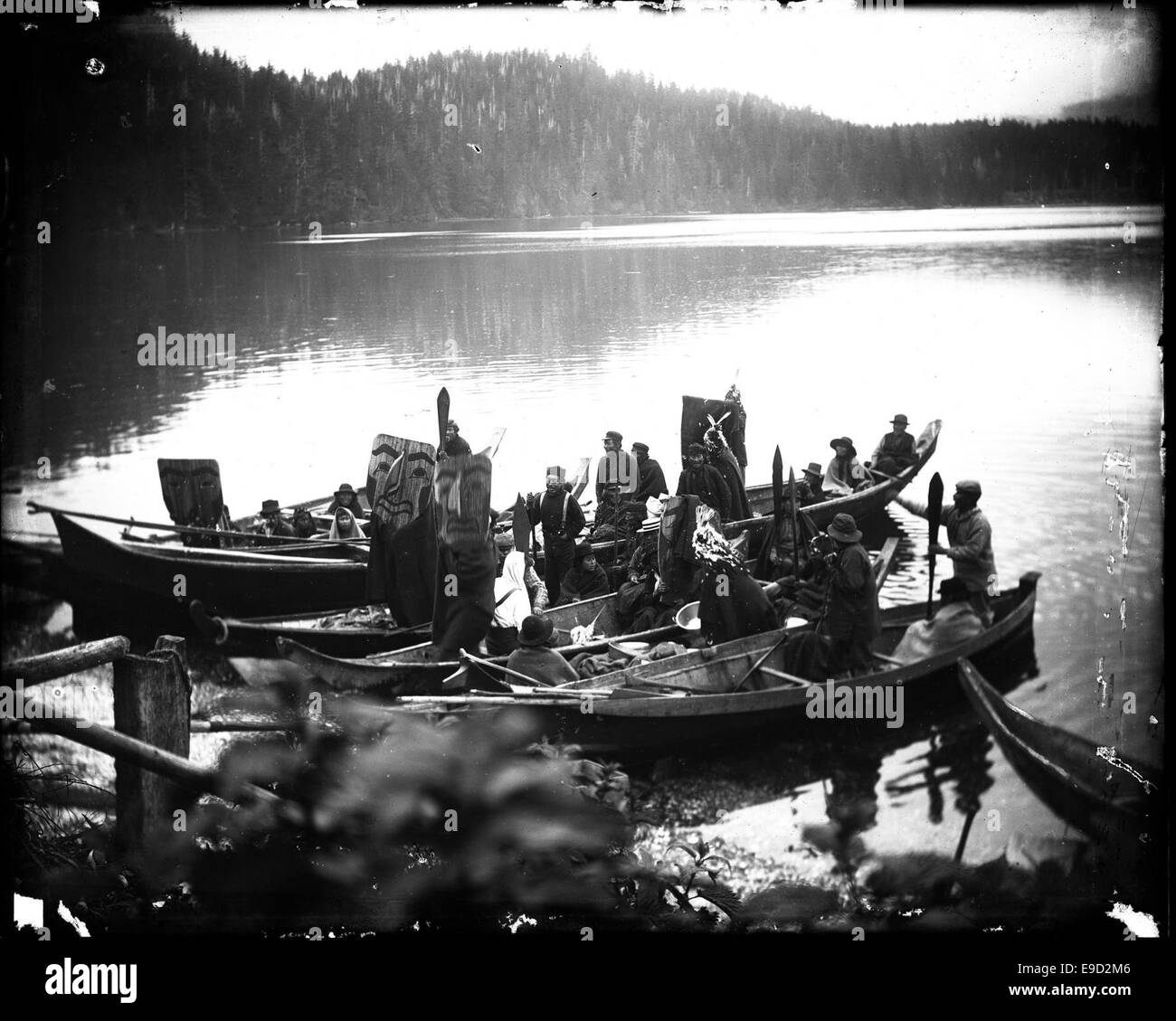 This photograph shows a group of First Nations people with their boats ...