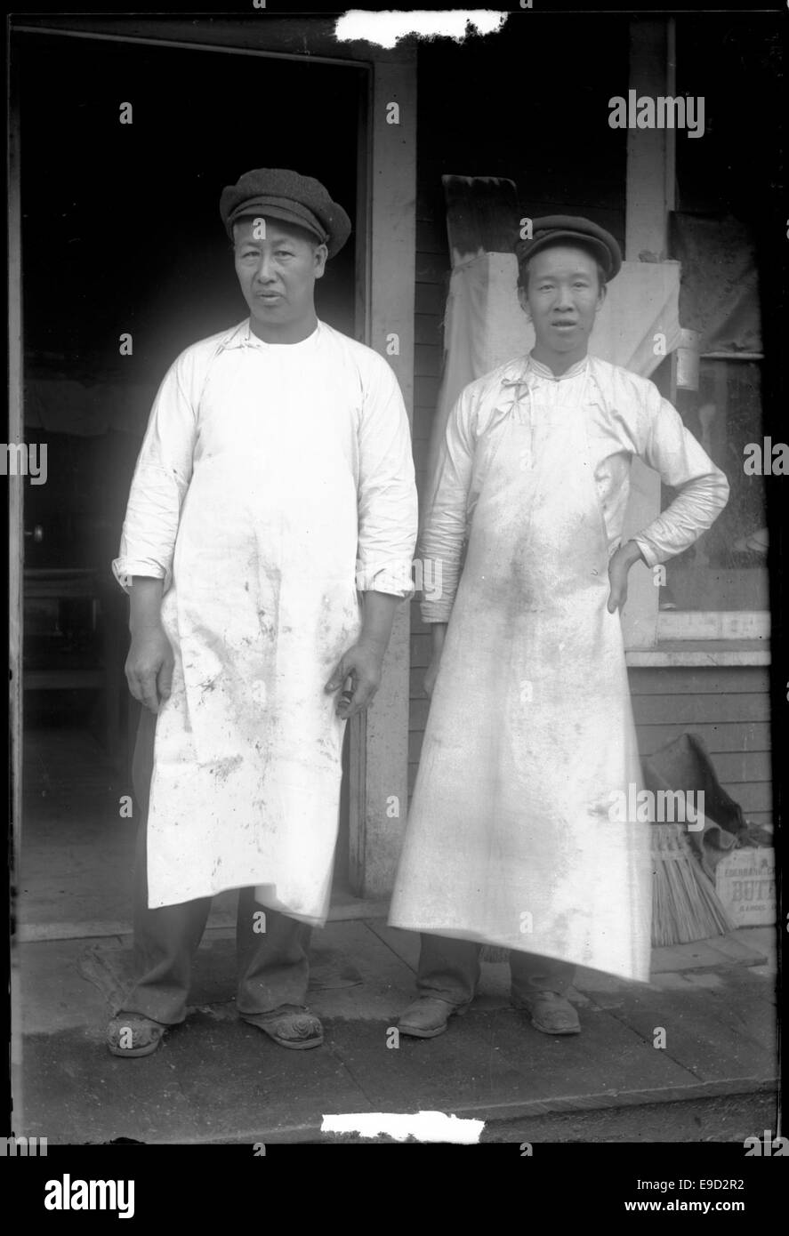A formal portrait of two Asian men, dressed in traditional or formal ...