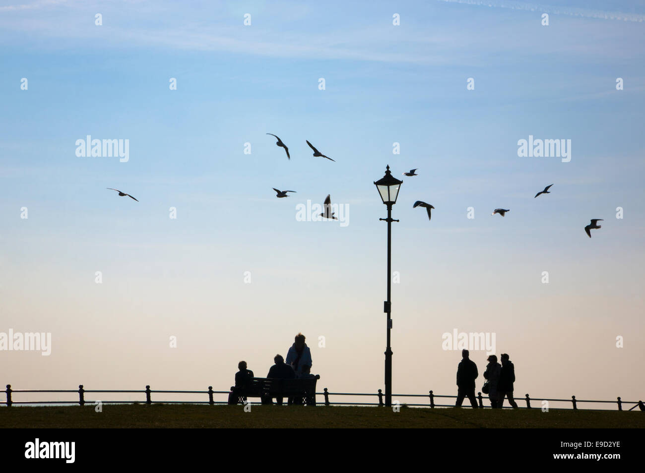 People silhouetted on Lytham promenade Stock Photo - Alamy