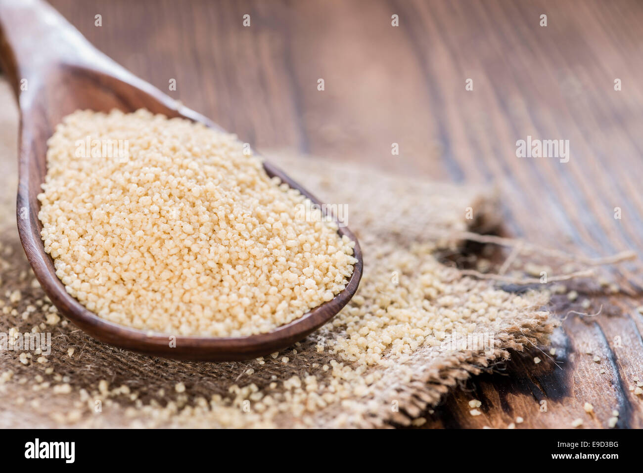 Heap of Couscous (close-up shot) on dark wooden background Stock Photo ...