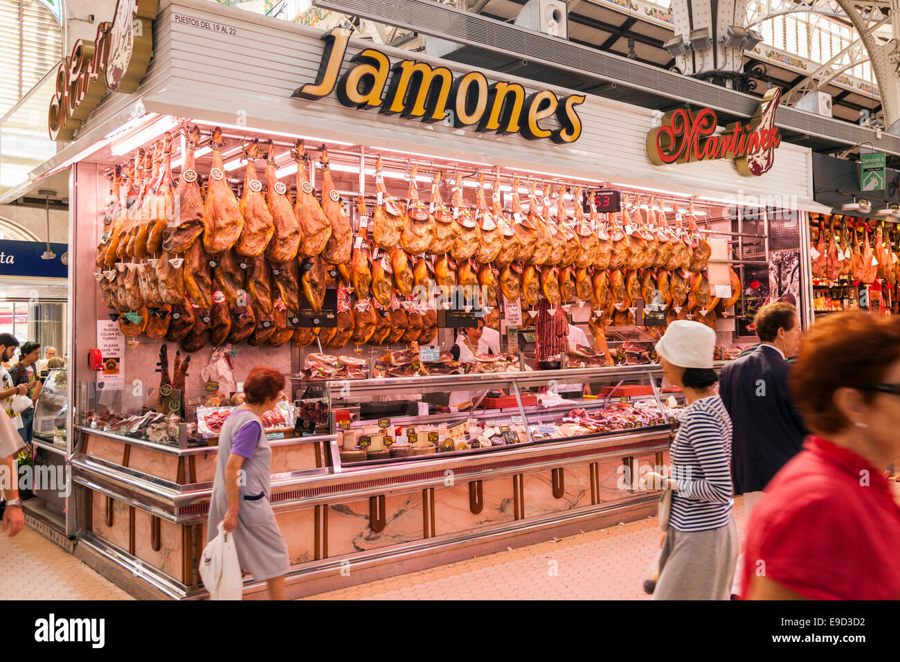 Jamon serrano on sale at stalls in the central market, Valencia, Spain ...