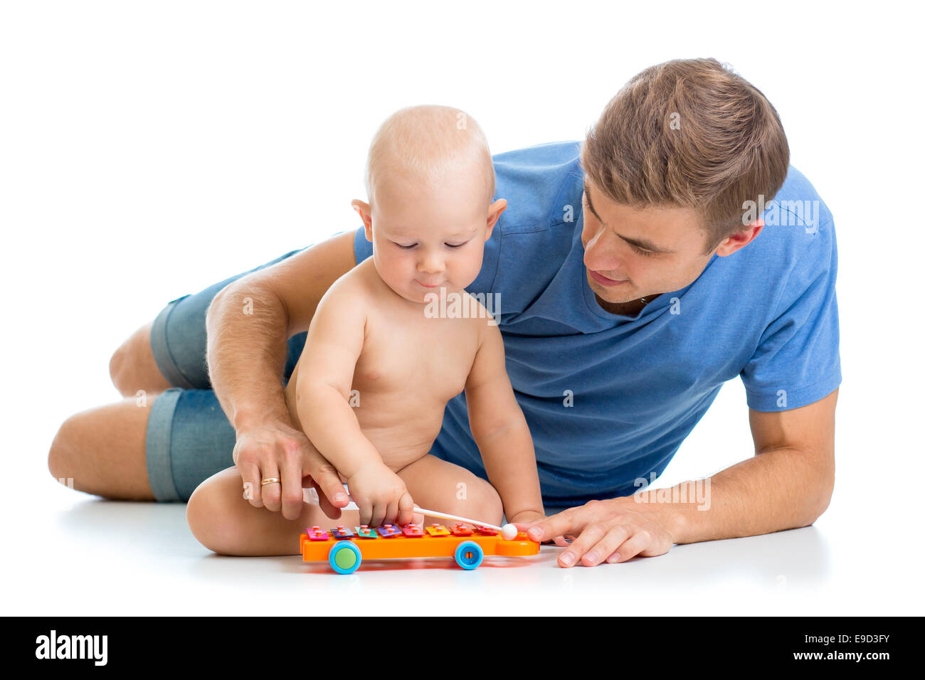 Father and baby boy have fun with musical toys Stock Photo - Alamy