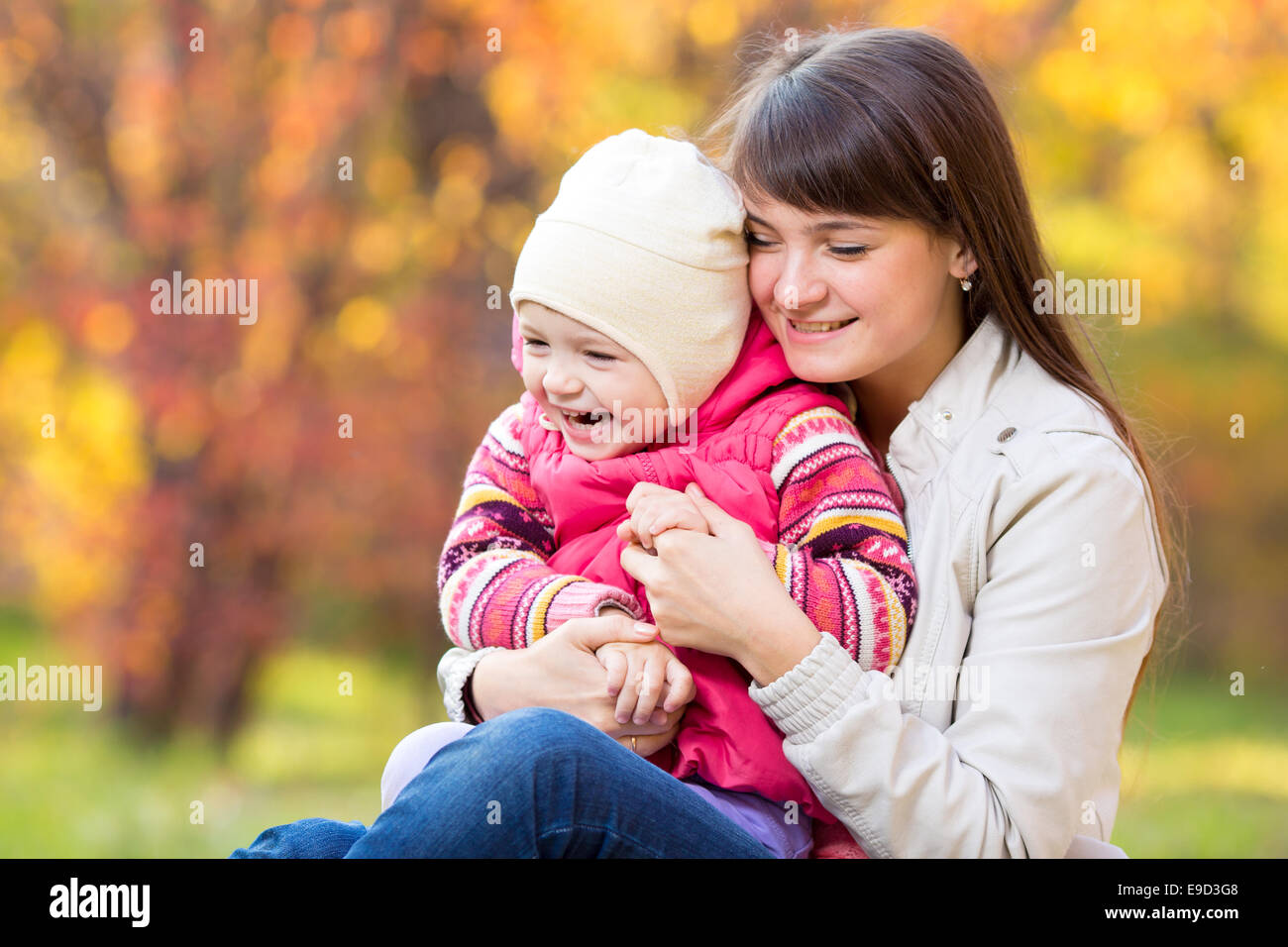 happy young mother and her daughter have fun sitting at autumn b Stock Photo - Alamy