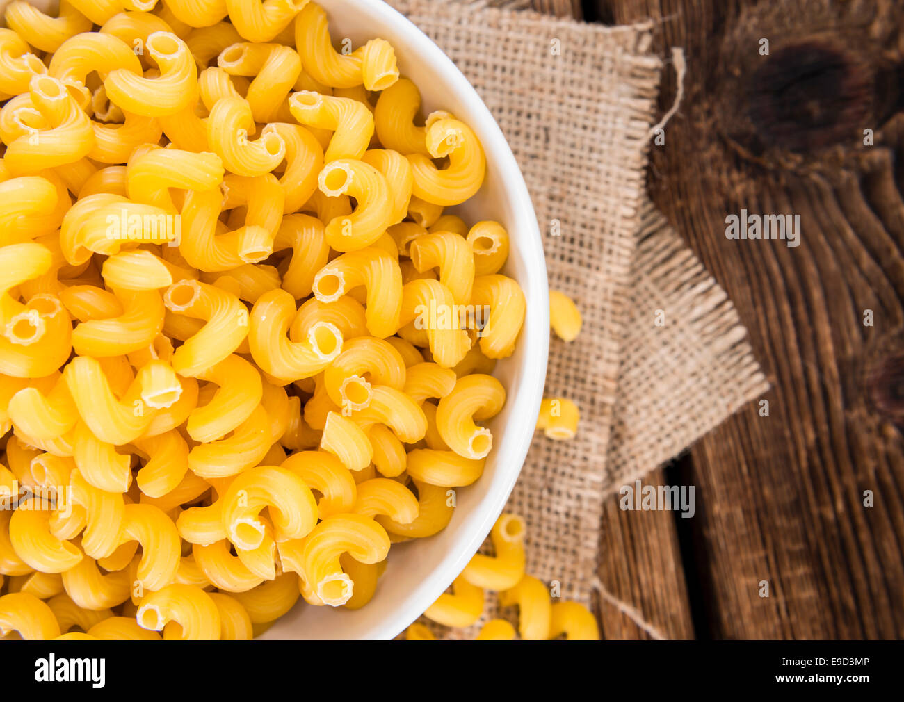 Portion of raw Pasta Curls on wooden background Stock Photo - Alamy