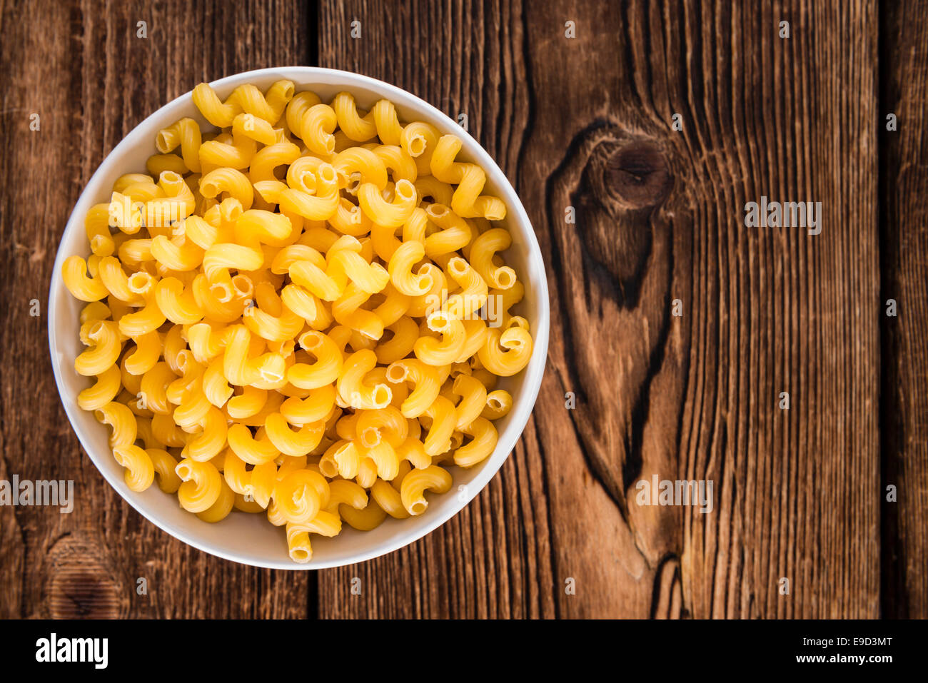 Pasta Curls (close-up shot) on dark wooden background Stock Photo - Alamy