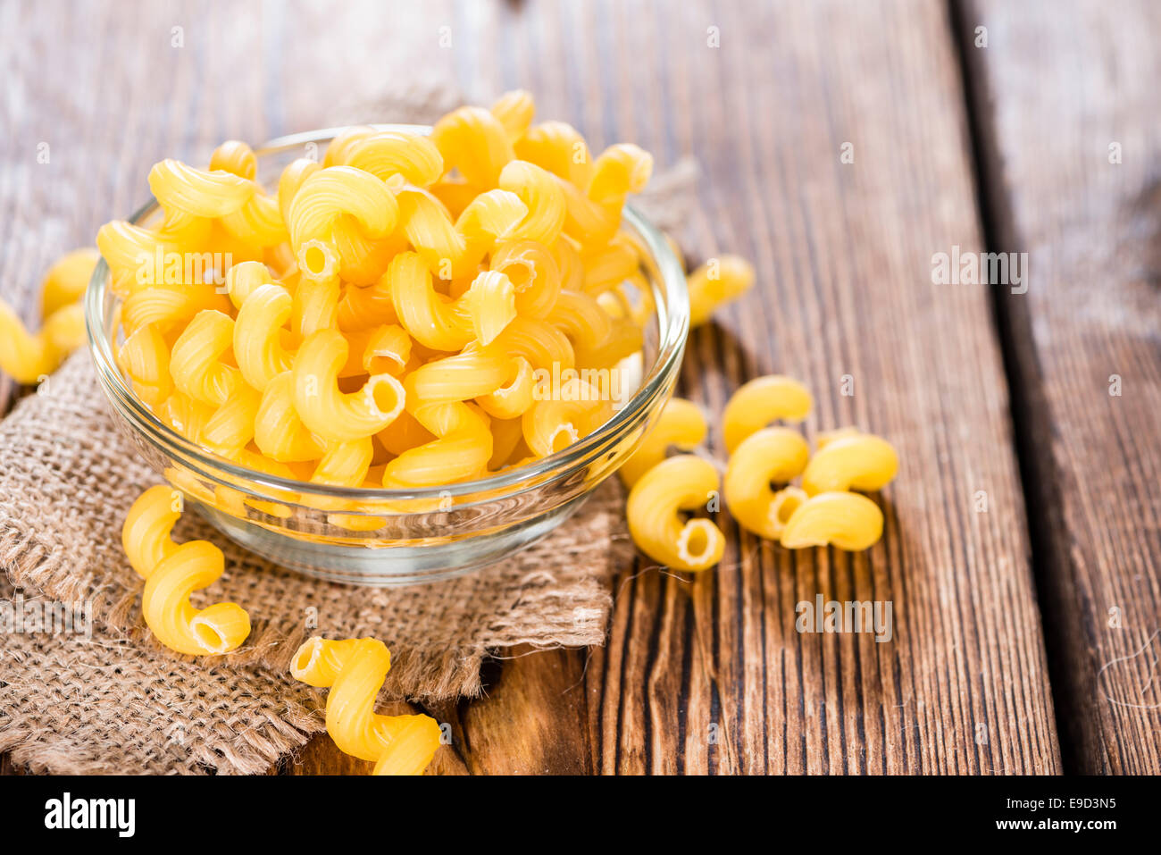 Bowl with raw Pasta Curls (on dark wooden background Stock Photo - Alamy