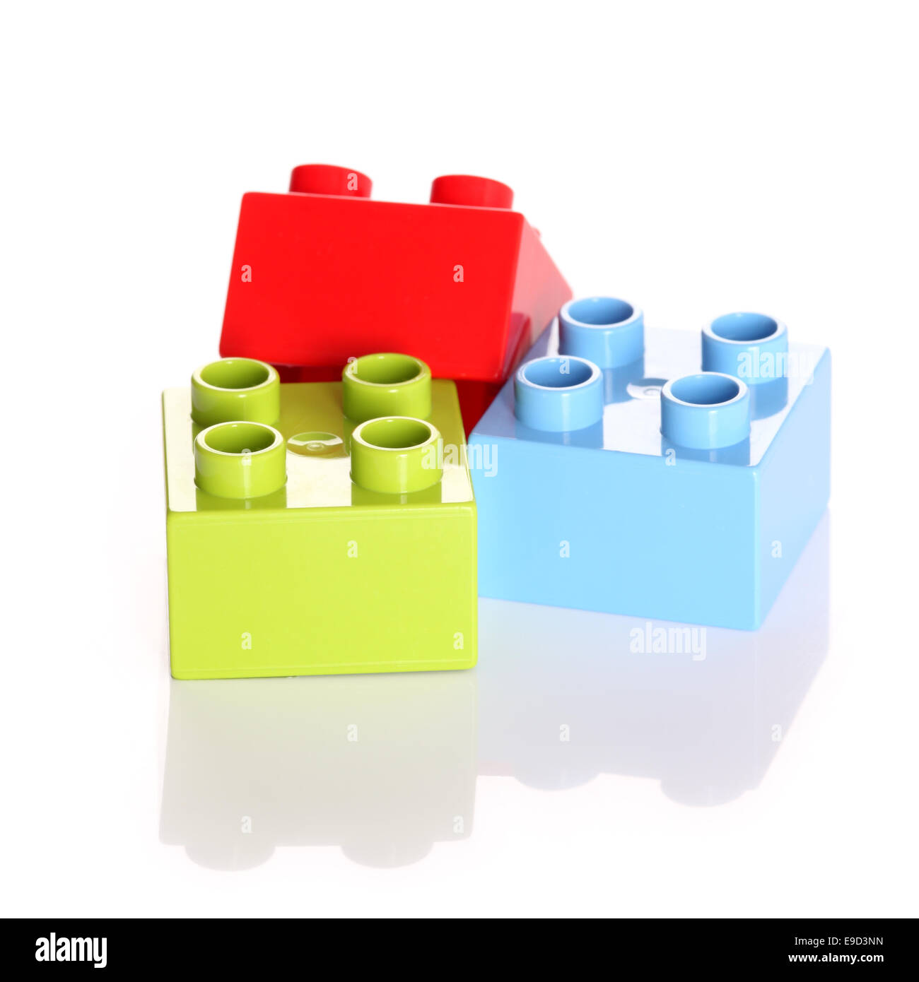 Three plastic toy blocks on white background Stock Photo - Alamy