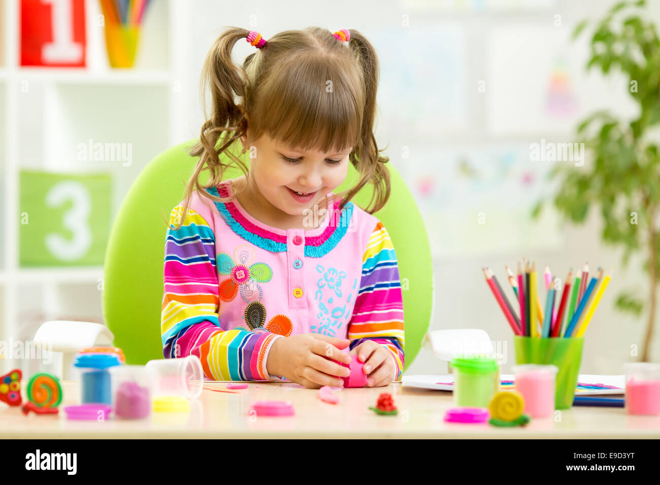 child girl playing with colorful clay Stock Photo - Alamy