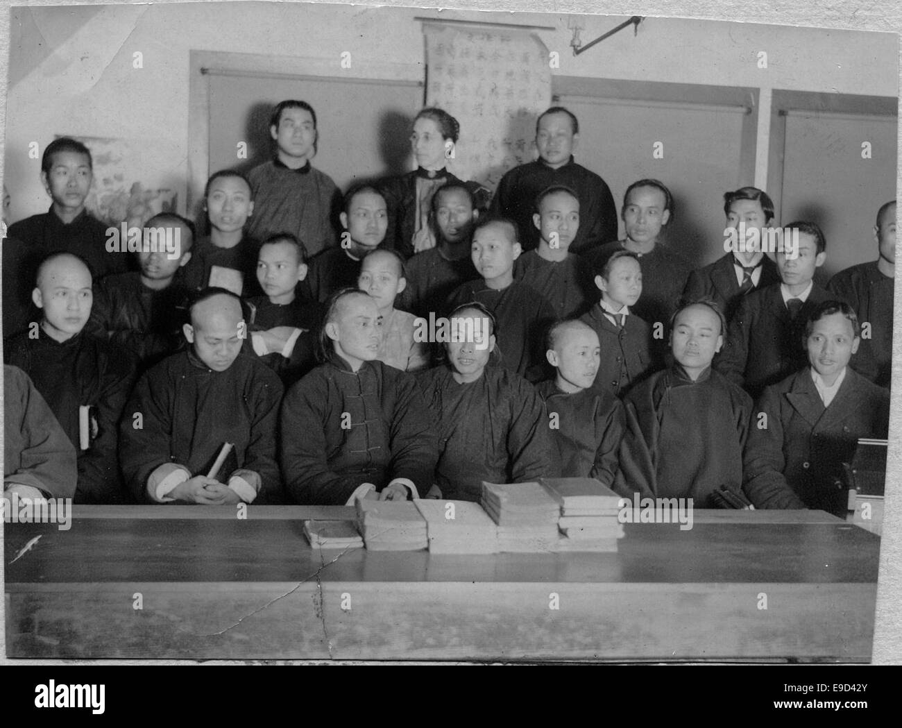 A photograph of a mission school, captured in a historical context. The ...