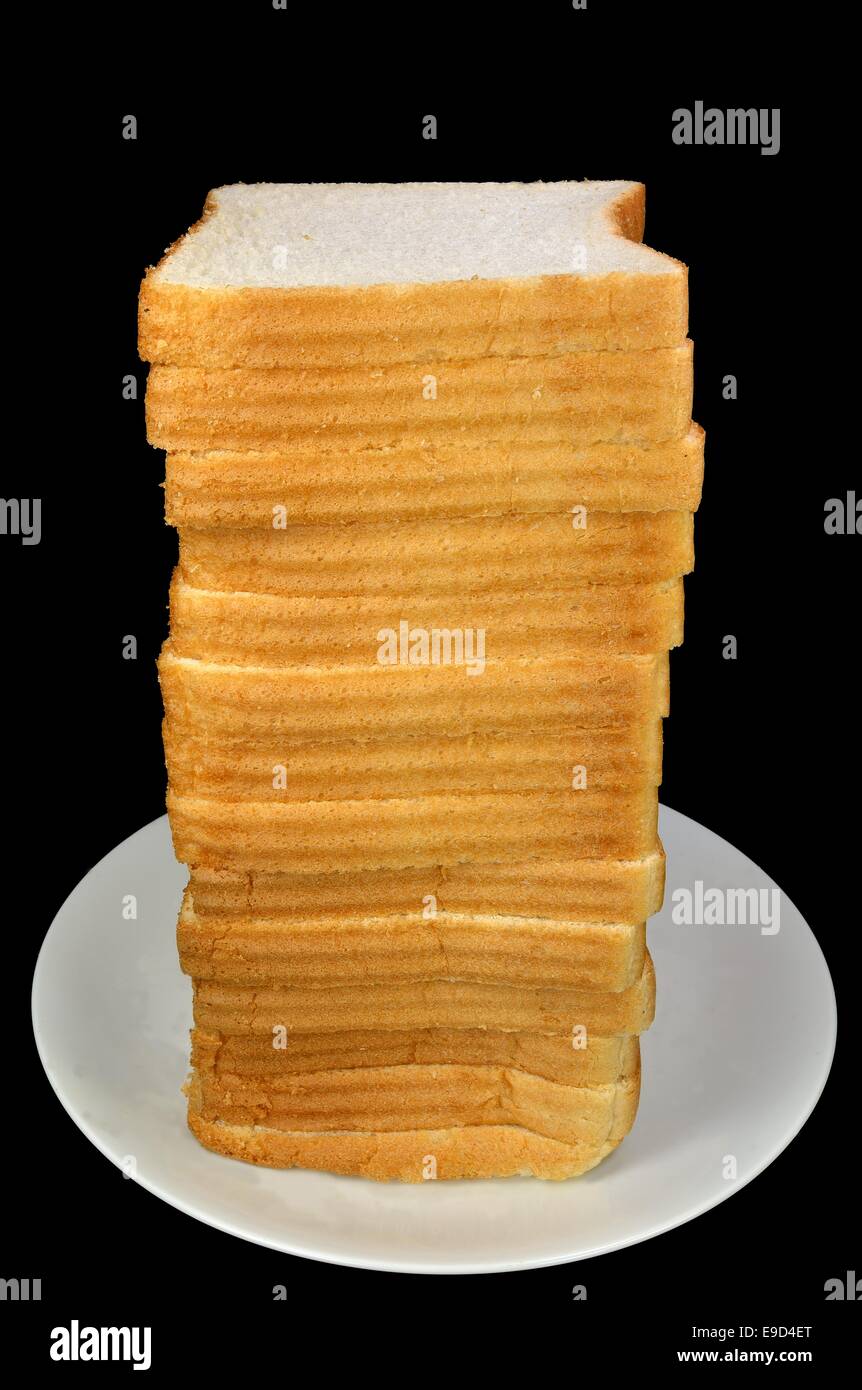 Tall stack of white bread on a black background Stock Photo - Alamy