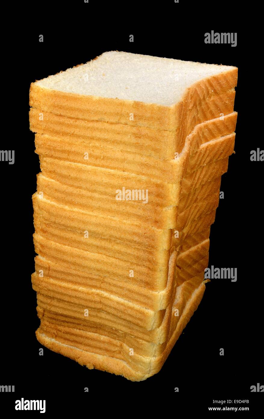 Tall stack of white bread on a black background Stock Photo - Alamy