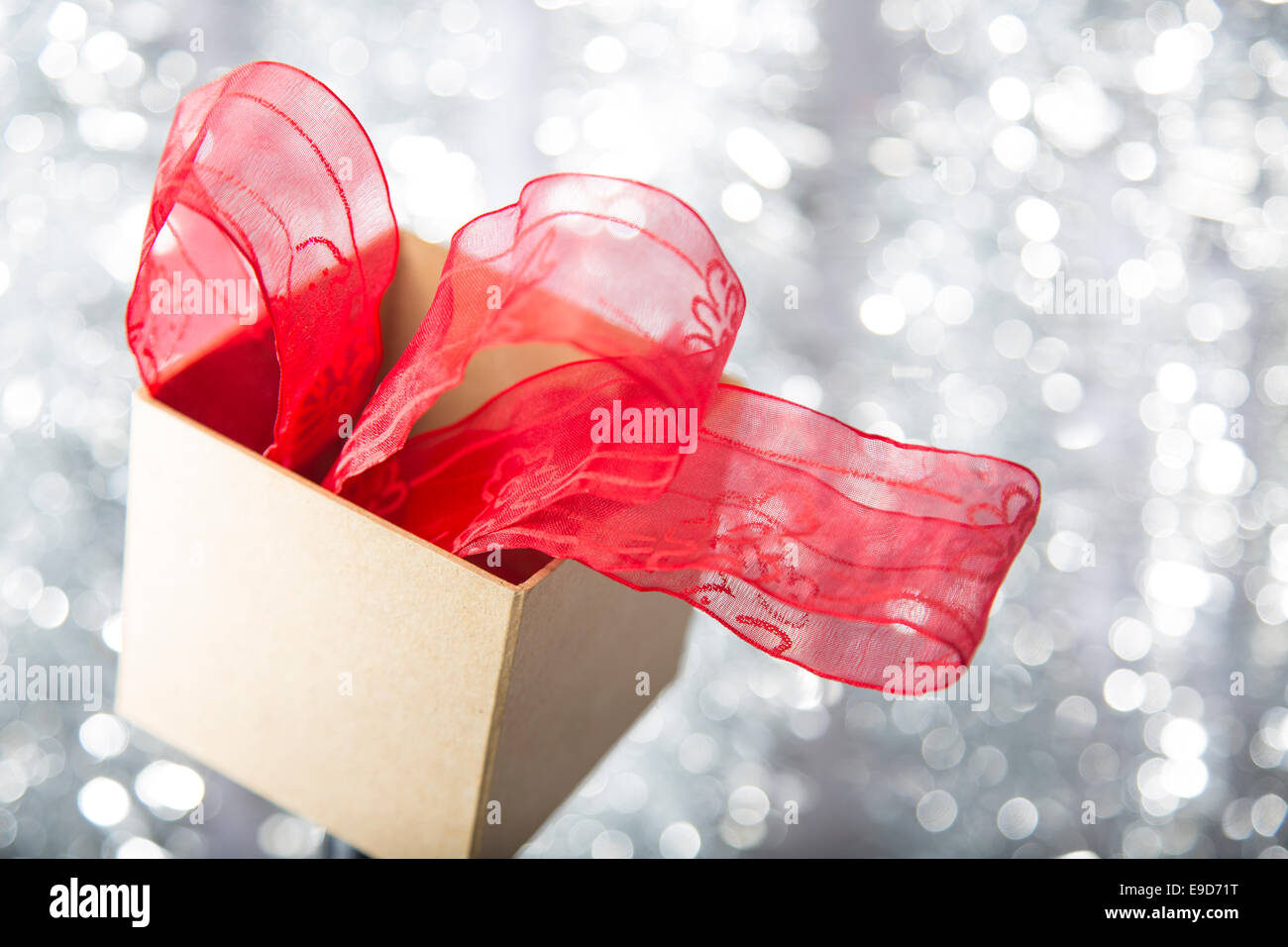 open christmas gift box with red ribbon in it Stock Photo - Alamy