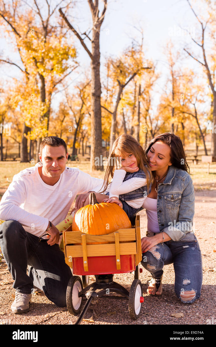 Taking large orange pumpkins home in red wagon from the pumkin path ...