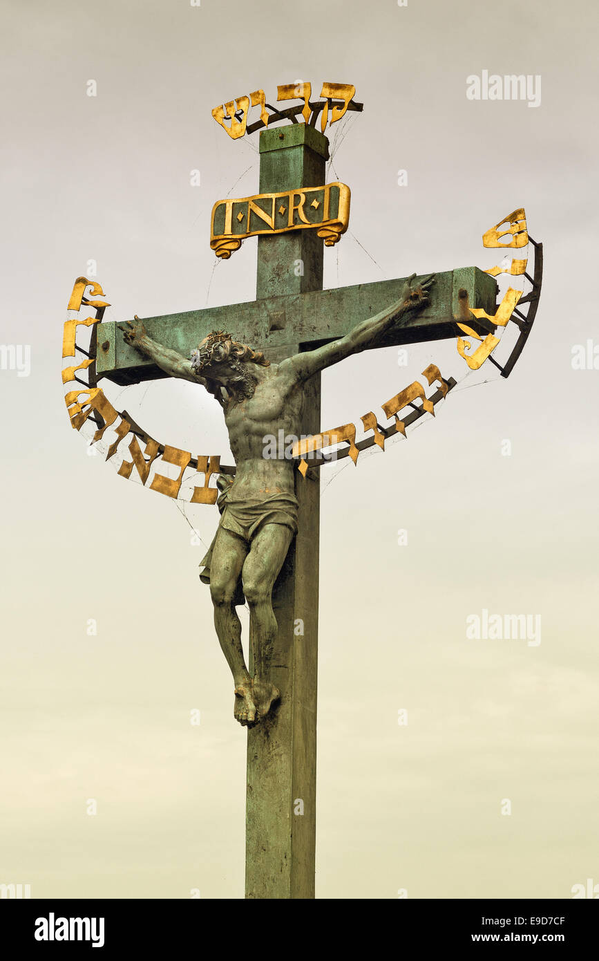 Monument of Jesus Christ crucifixion at Charles Bridge in Prague with ...