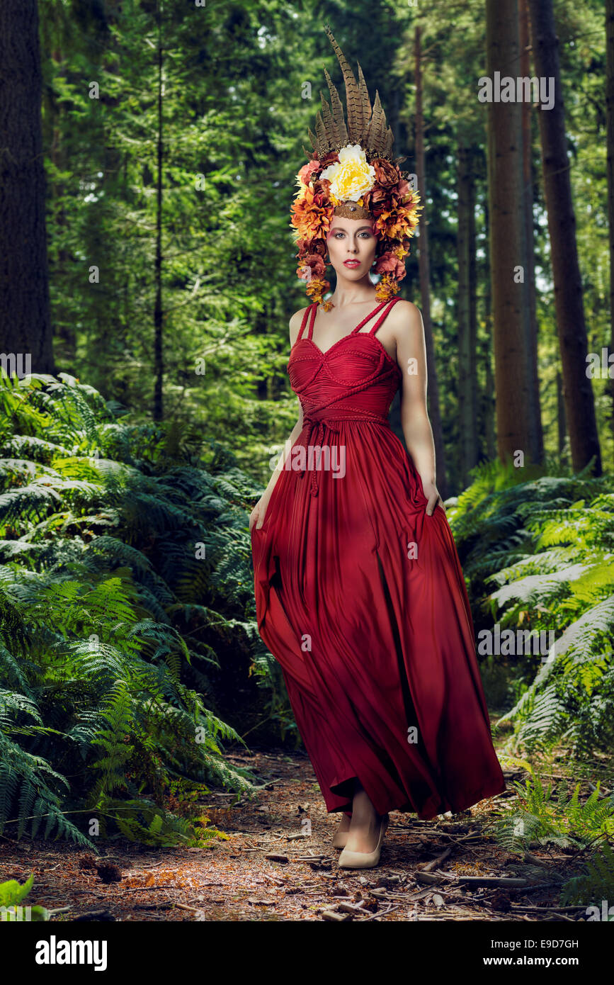 Beautiful forest nymph in red dress and flowery headpiece Stock Photo ...