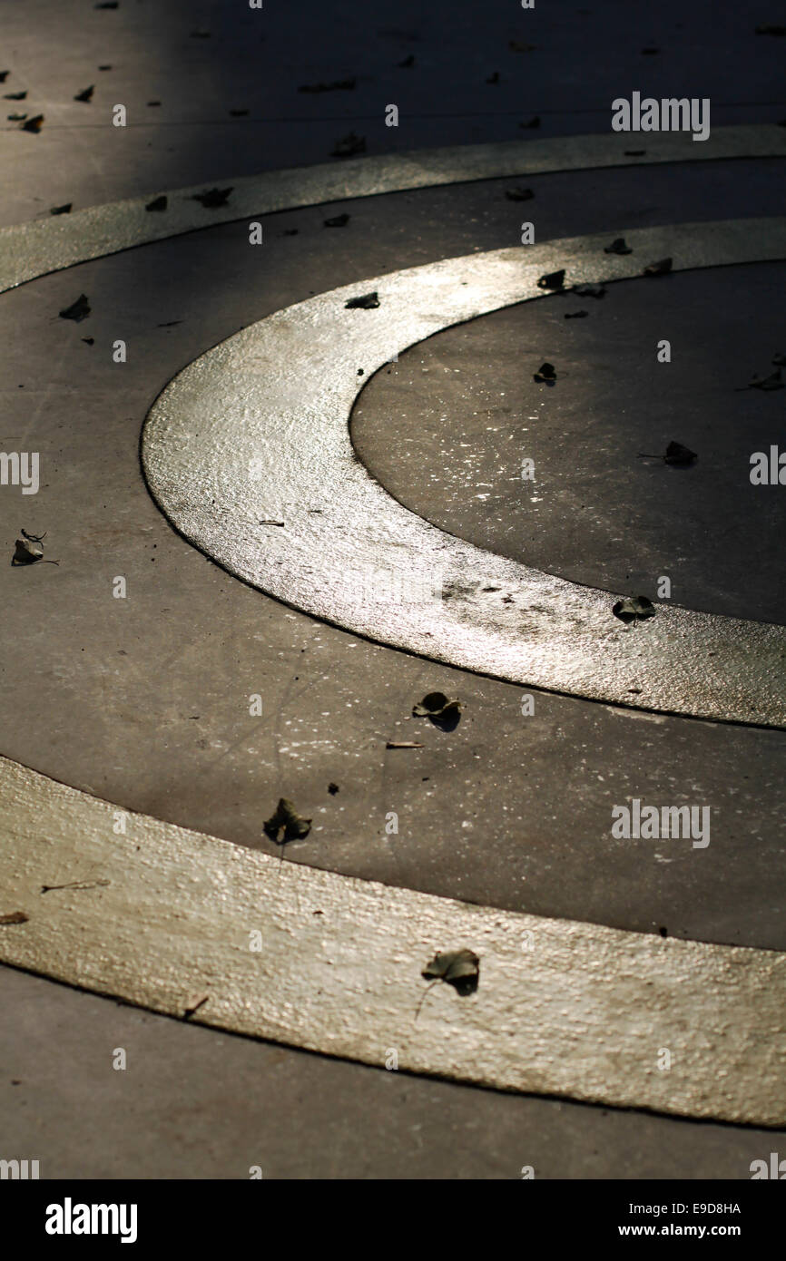 Circle shape on cement floor covered with leaves Stock Photo - Alamy
