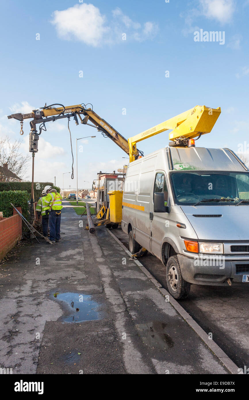 Workmen drilling holes to erect telegraph poles for telephone cables ...