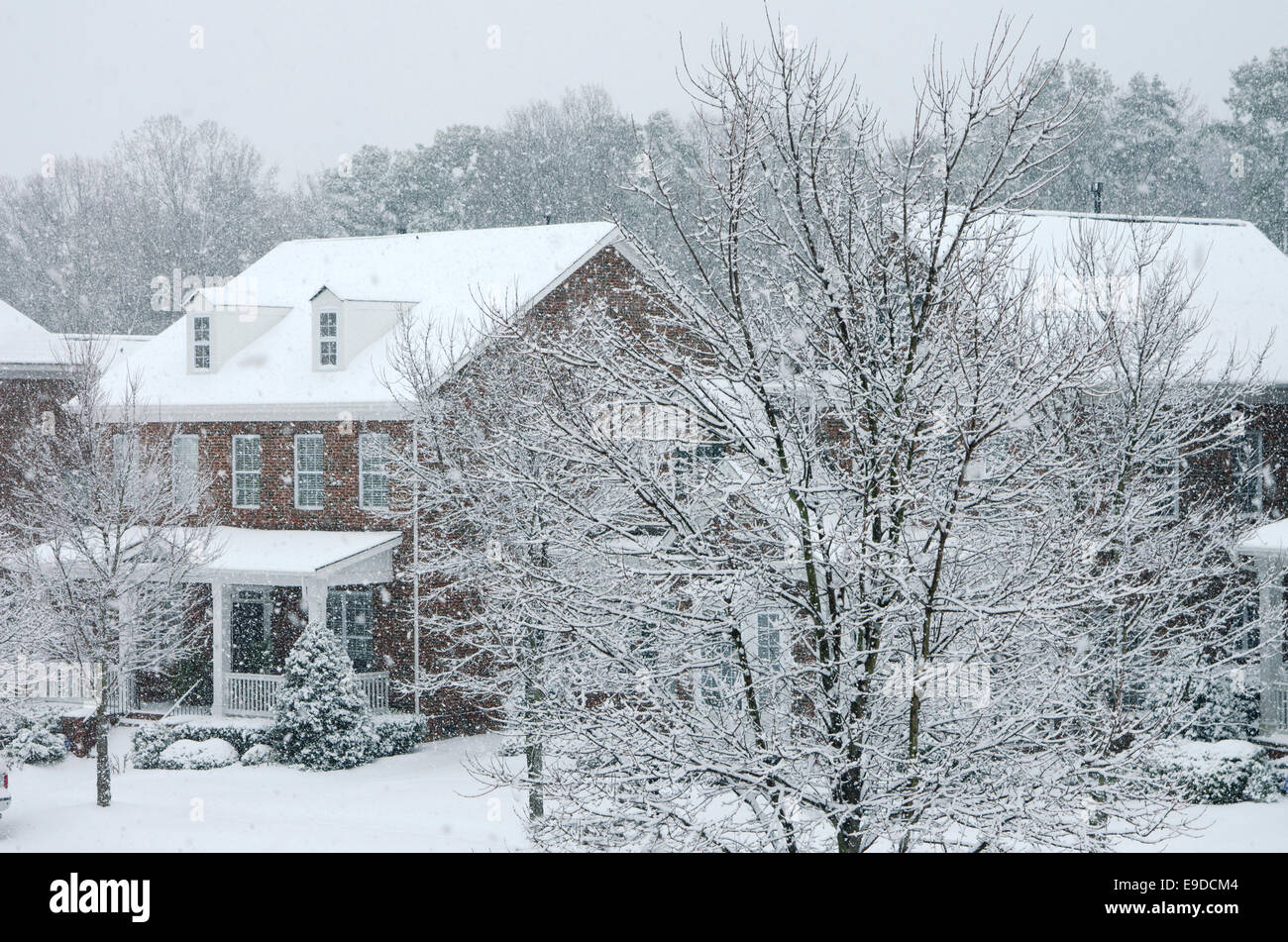 A traditional, brick homes are captured during a snow storm in this ...