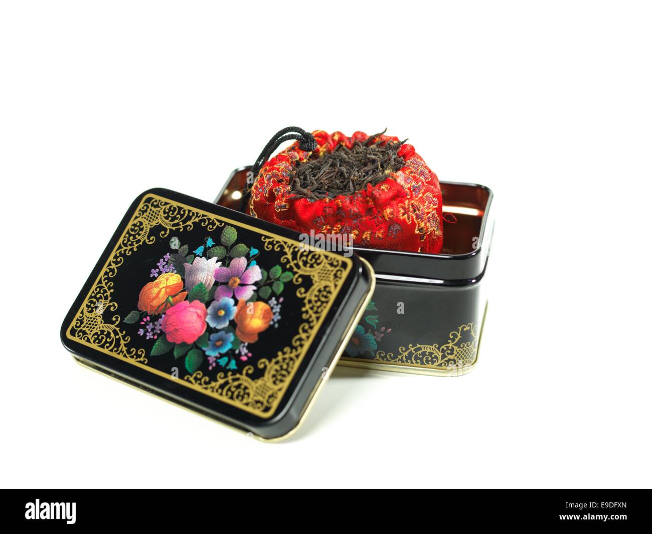 A colorful tin box with a bag of a black tea Stock Photo - Alamy