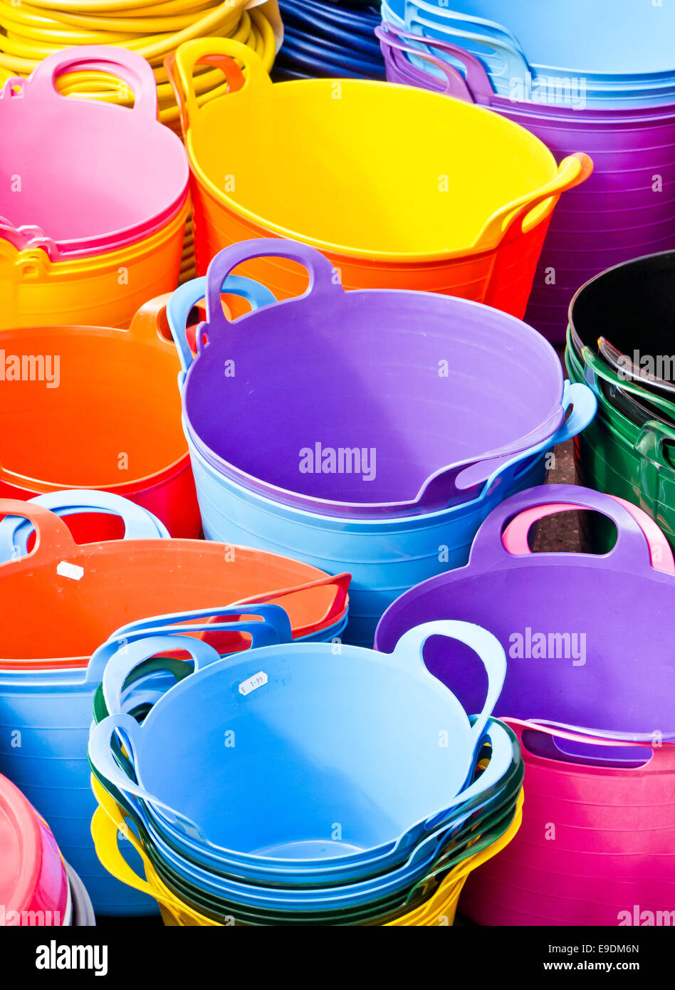 Selection of colorful plastic tubs at a market Stock Photo - Alamy
