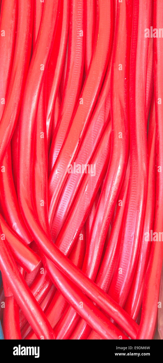 Red chewy strawberry laces as a background image Stock Photo - Alamy