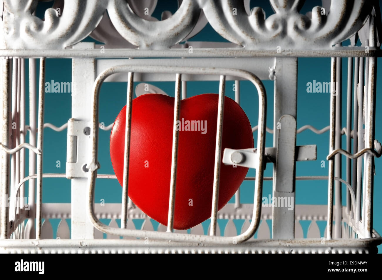 a red heart in a white cage Stock Photo - Alamy