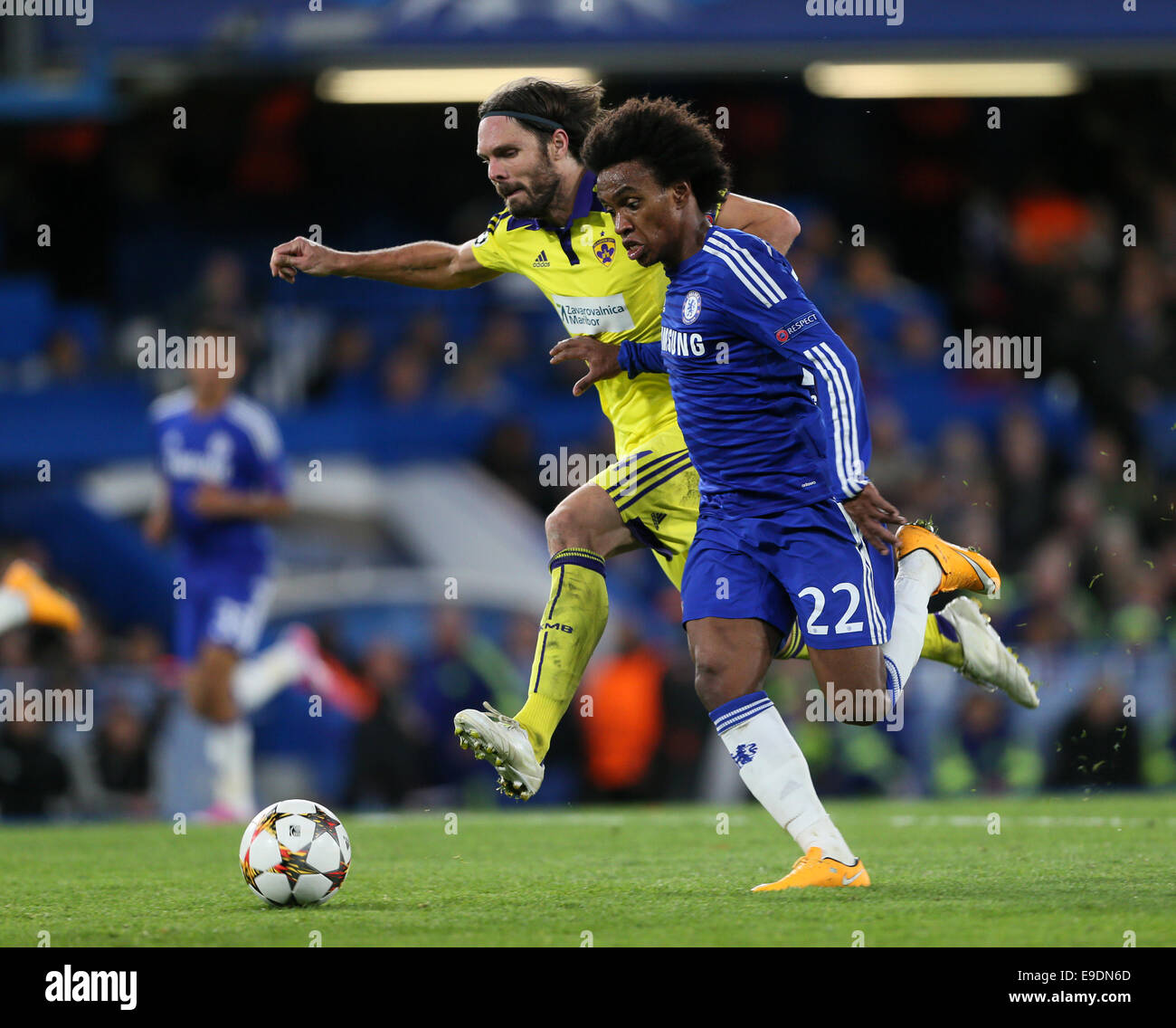 London, UK. 21st Oct, 2014. Chelsea's Willian tussles with Maribor's ...