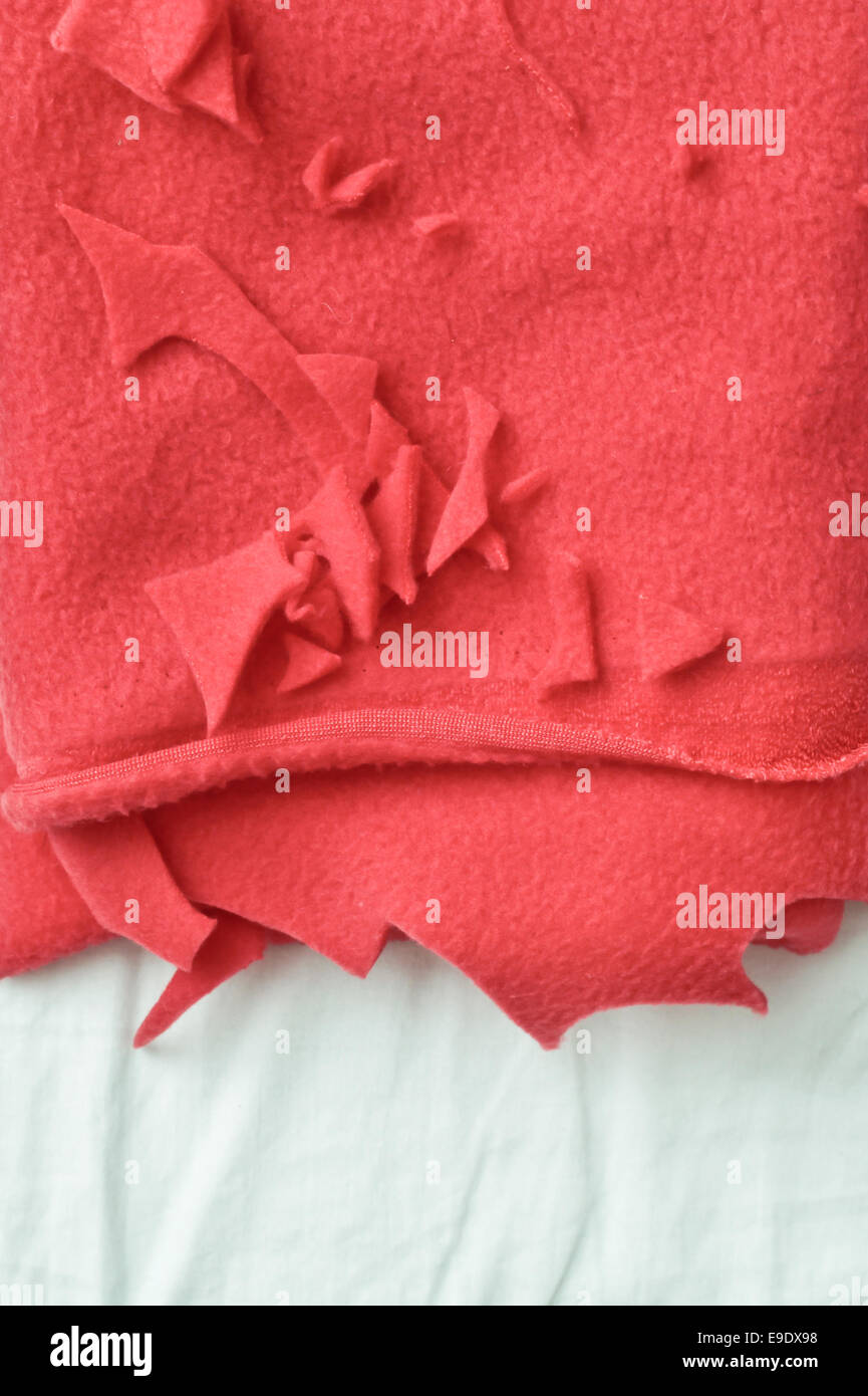 Folded red fleece material with offcuts Stock Photo - Alamy