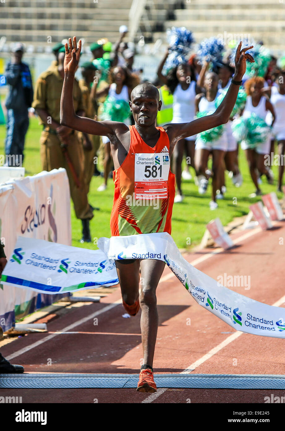 Nairobi, Kenya. 26th Oct, 2014. Peter Kosgei of Kenya runs across the finishing line during the ...