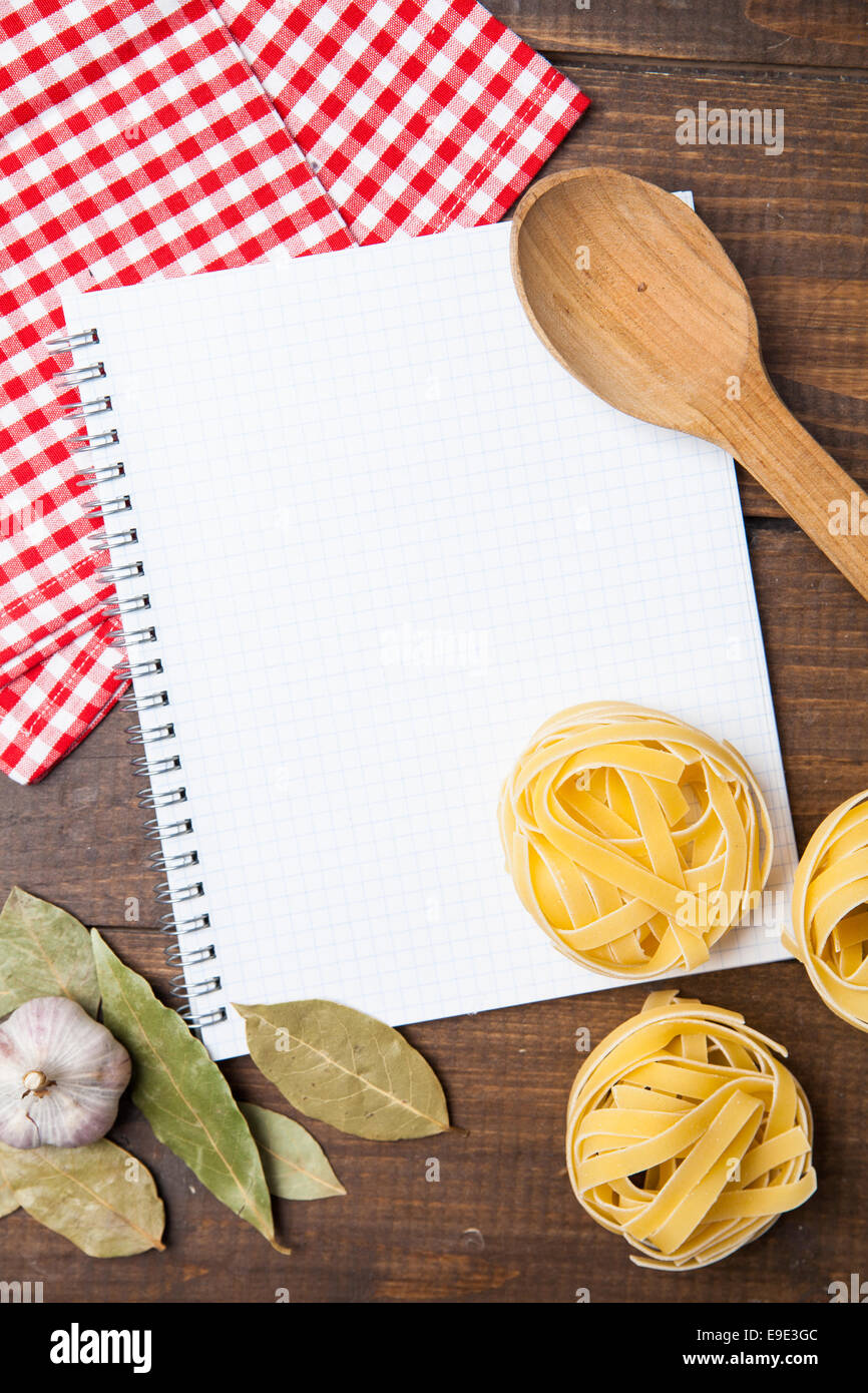 blank paper for recipes with ingredients, pasta, pepper and spices on ...
