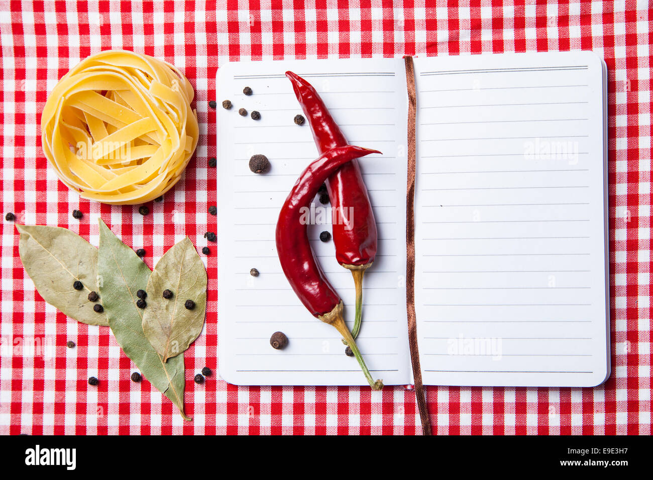 blank paper for recipes with ingredients, pasta, pepper and spices on ...