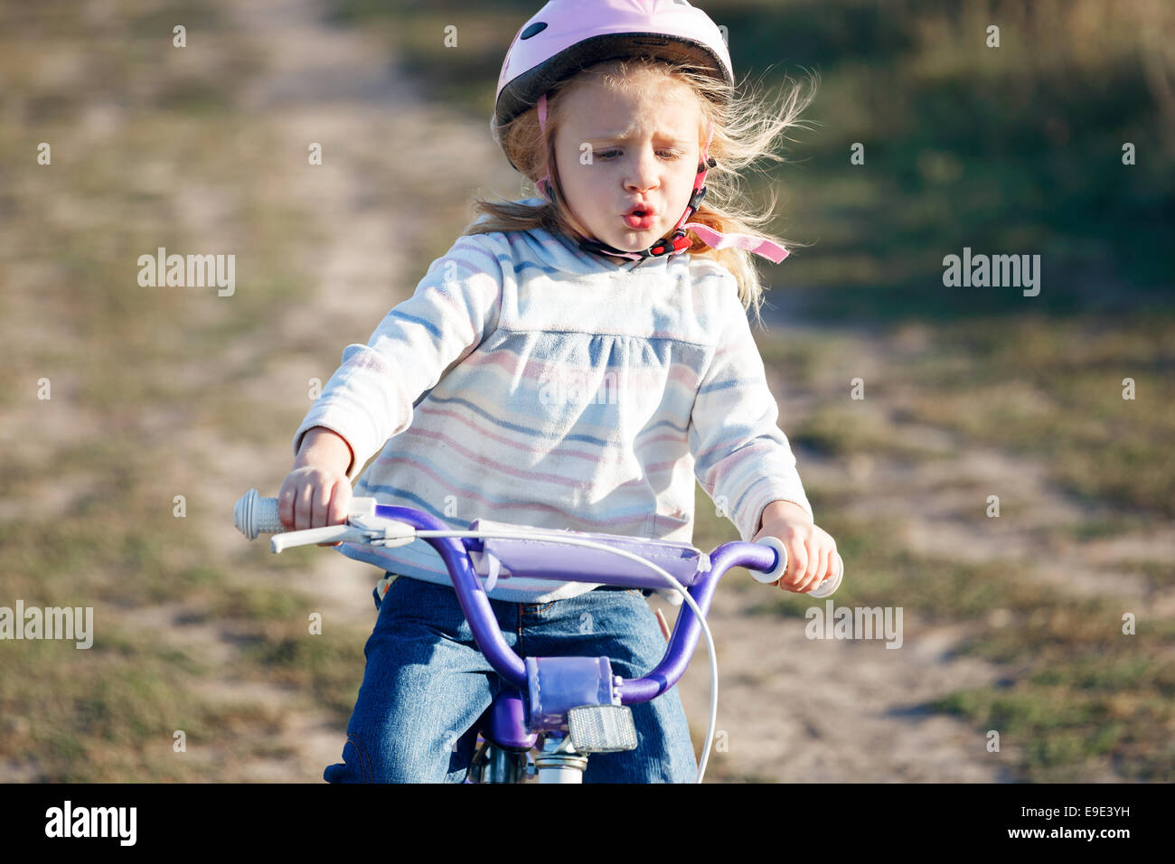 Small funny kid riding bike with training wheels Stock Photo - Alamy