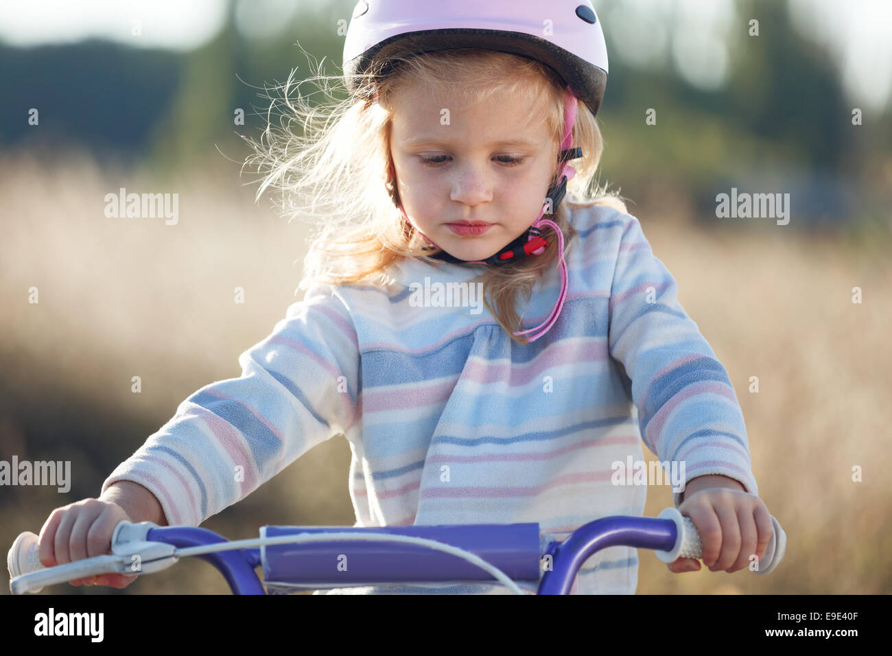 Small funny kid riding bike with training wheels Stock Photo - Alamy