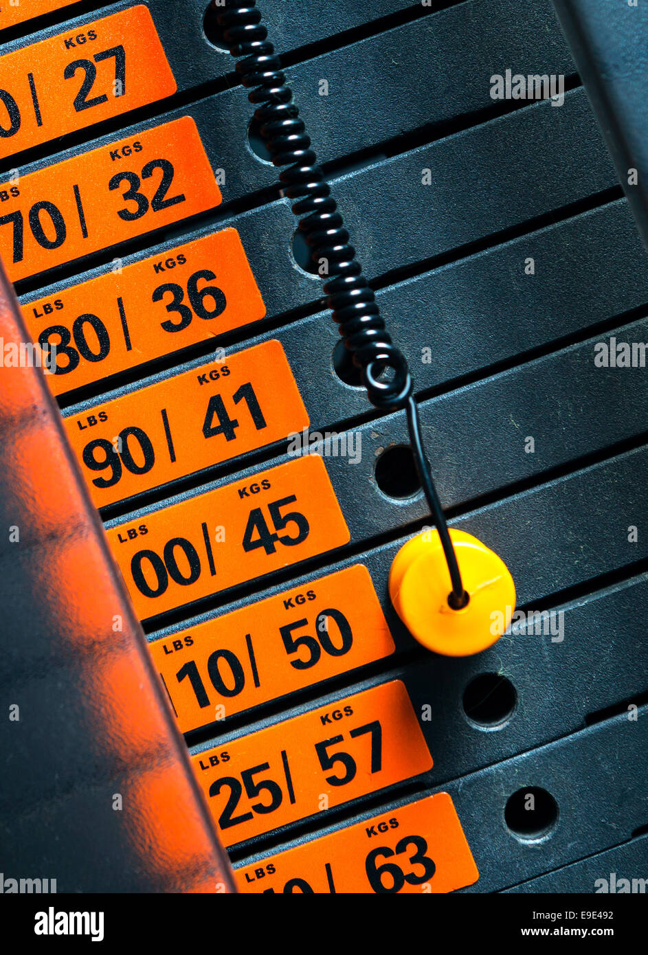 Closeup of weight stack with orange pin Stock Photo - Alamy
