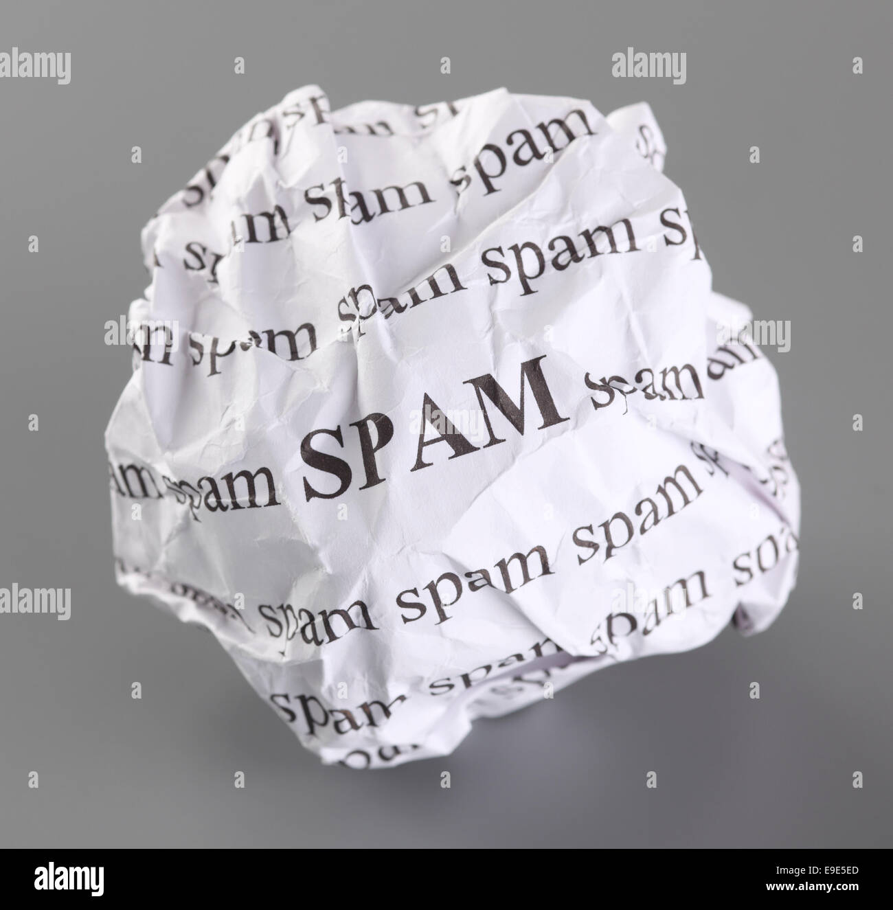 Crumpled paper ball with words "Spam" on gray background Stock Photo ...