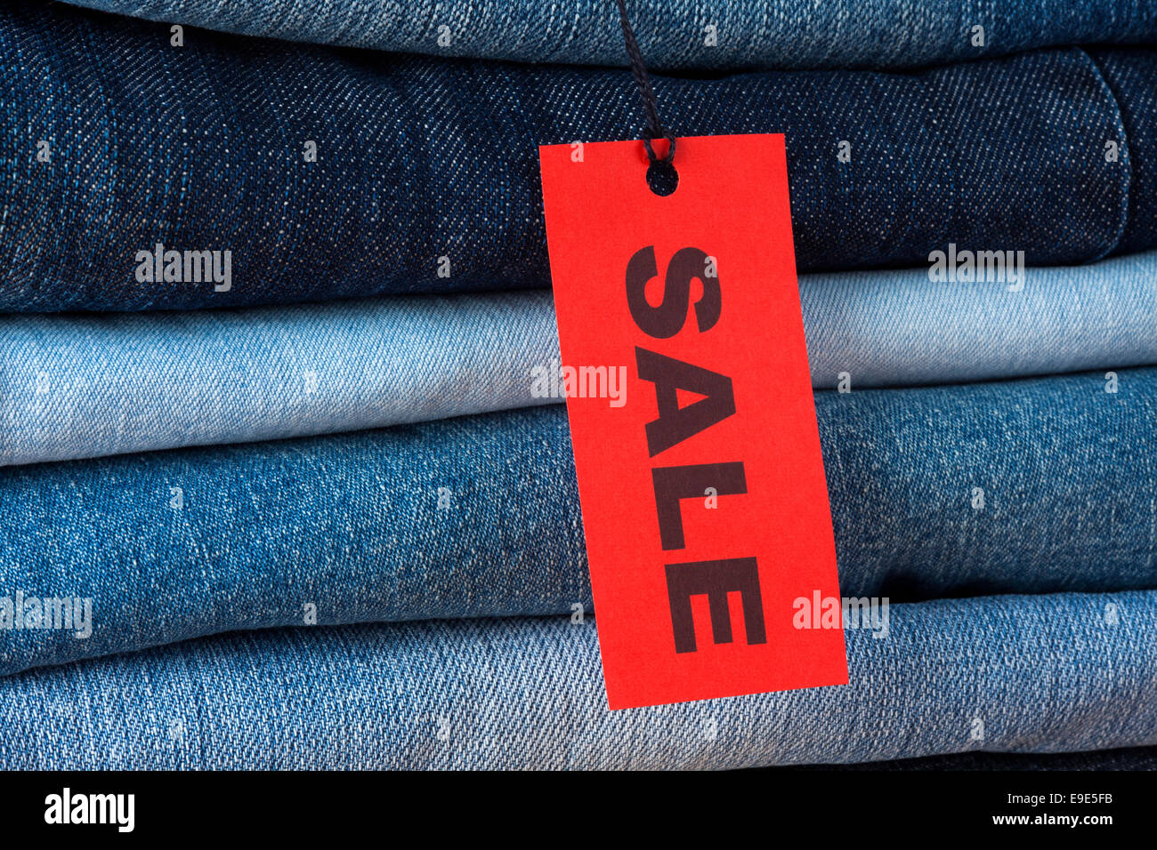Stack of jeans with sale label Stock Photo - Alamy