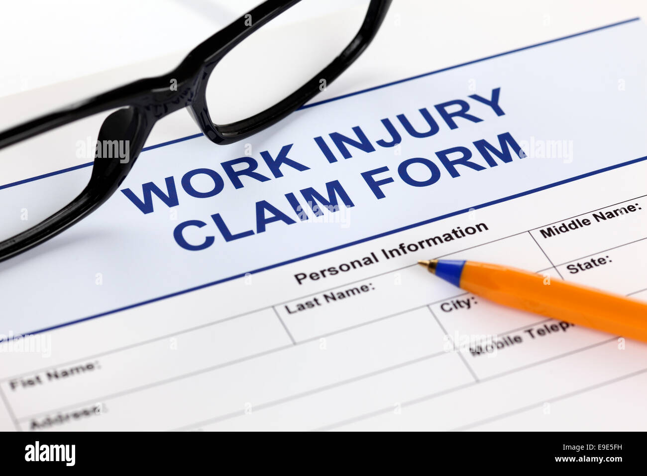 Work Injury claim form glasses and ballpoint pen Stock Photo - Alamy