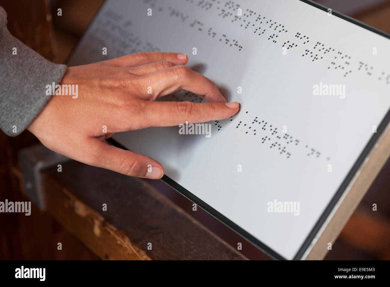 Close-up of human hand reading braille sign Stock Photo - Alamy