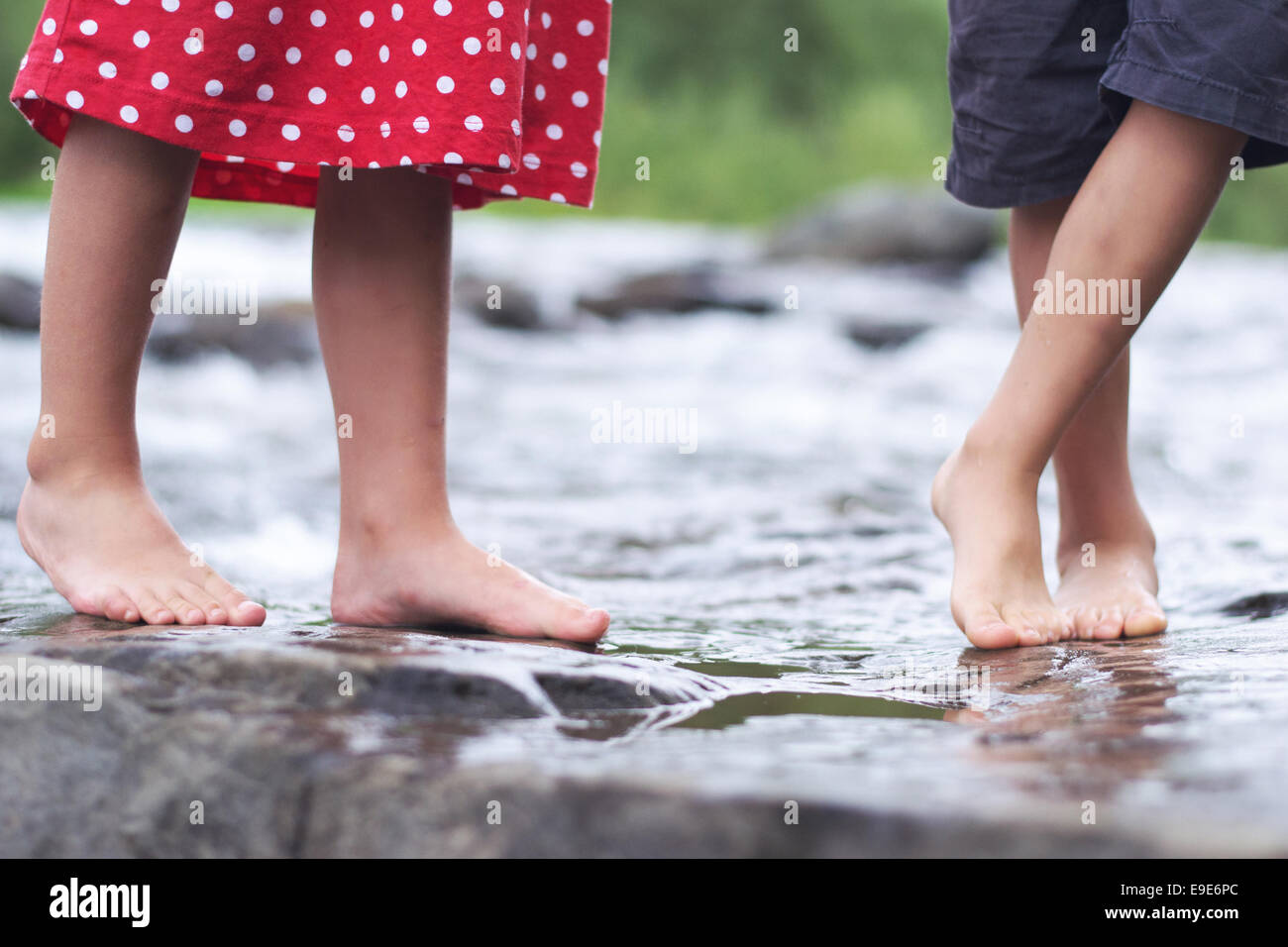 Children soaking feet in a stream Stock Photo - Alamy